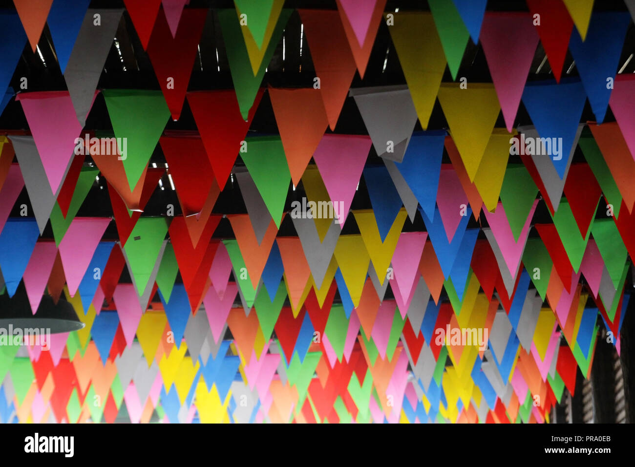 pile of colorful triangle flag decorated on the ceiling Stock Photo - Alamy