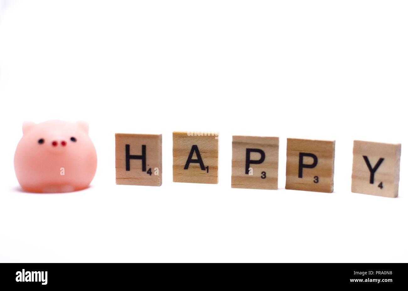 Mini pink pig and the wooden alphabets with word HAPPY, a cute little ...