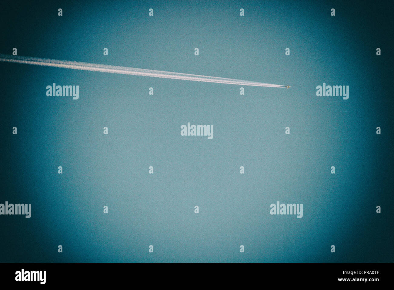 Wallpaper background of an airplane trace in the blue sky. Vignette ...
