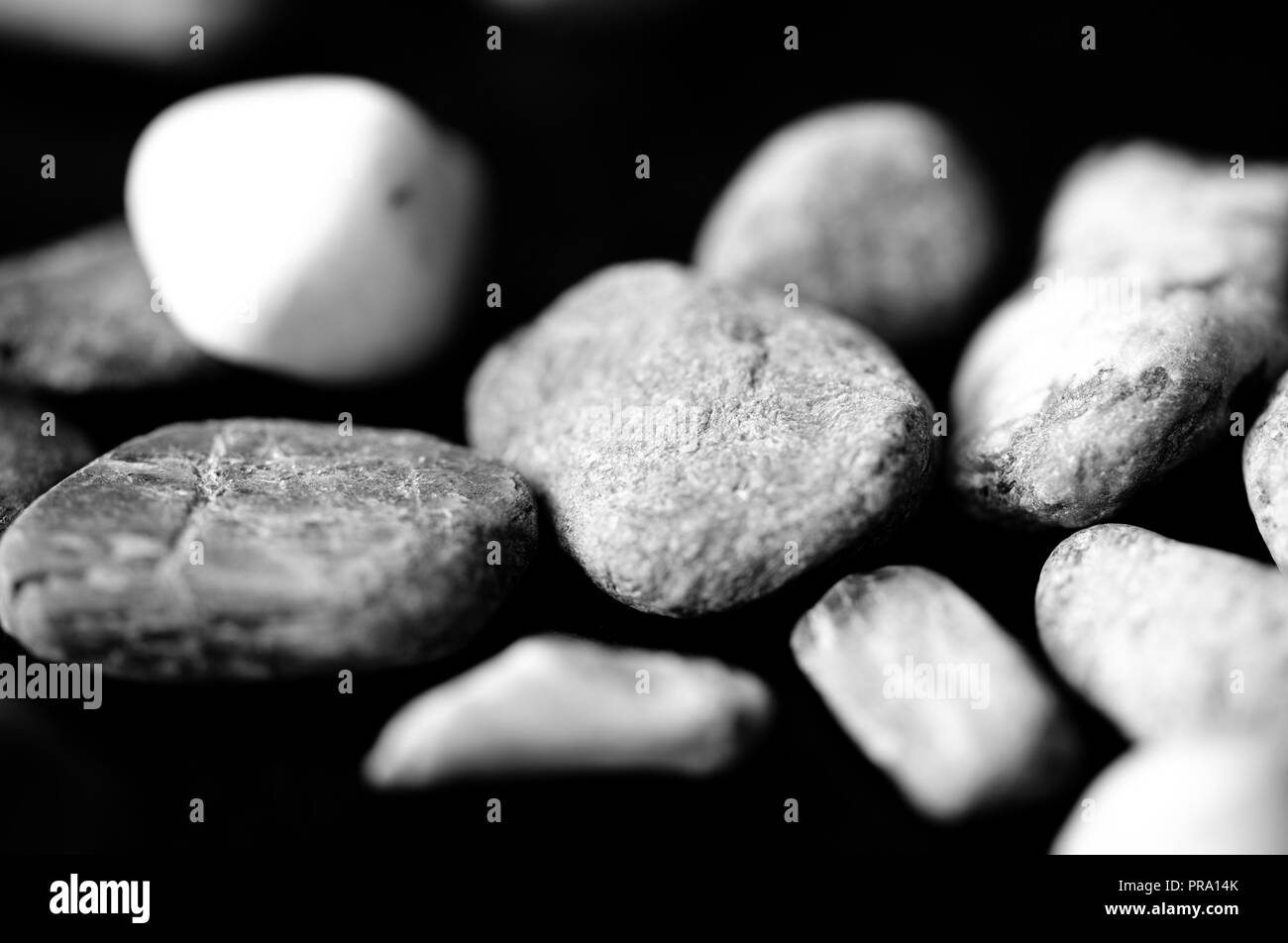 Scattered stones on a dark background close up. Black and white Stock ...