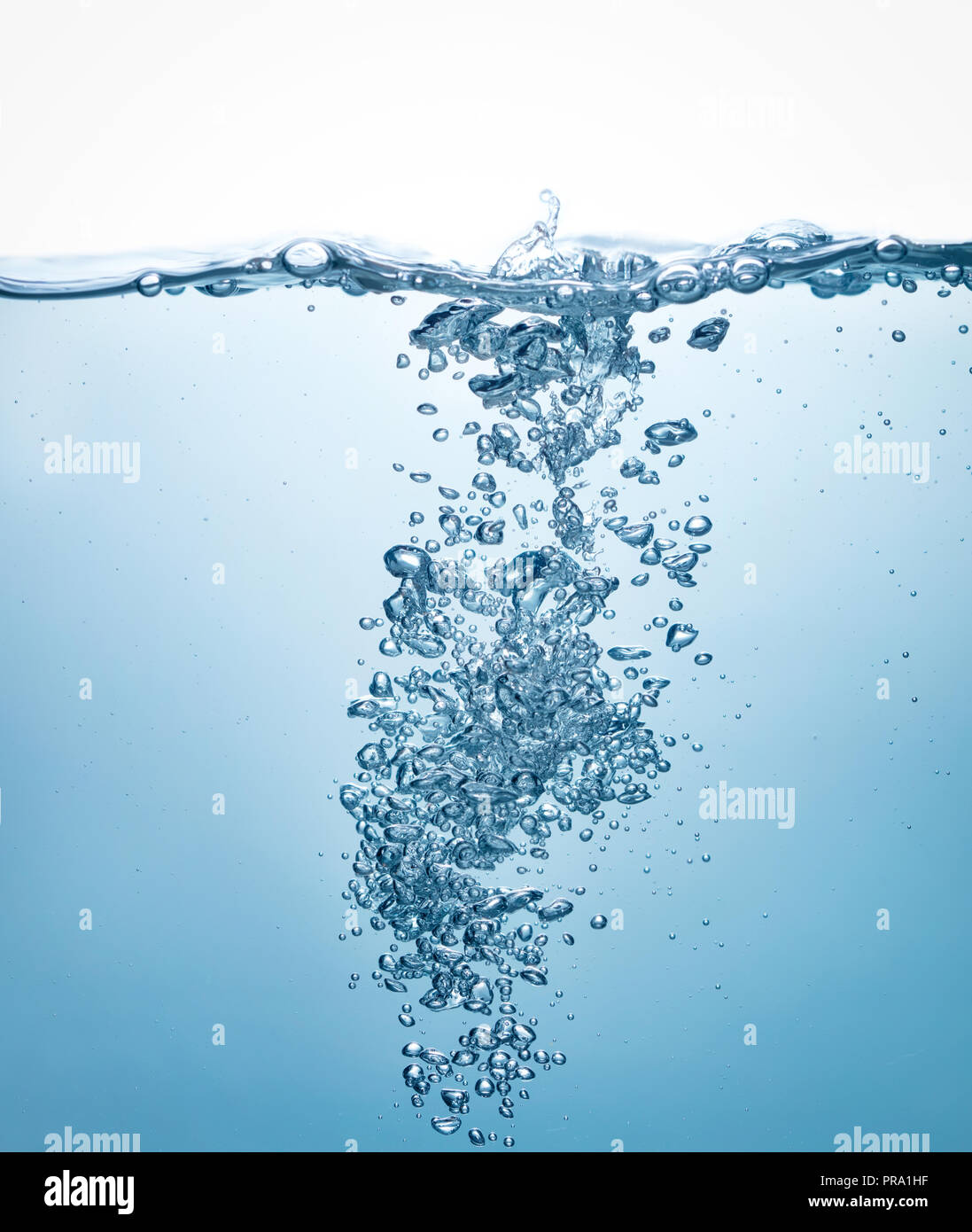 pure blue water surface with splash and air bubbles on white background ...