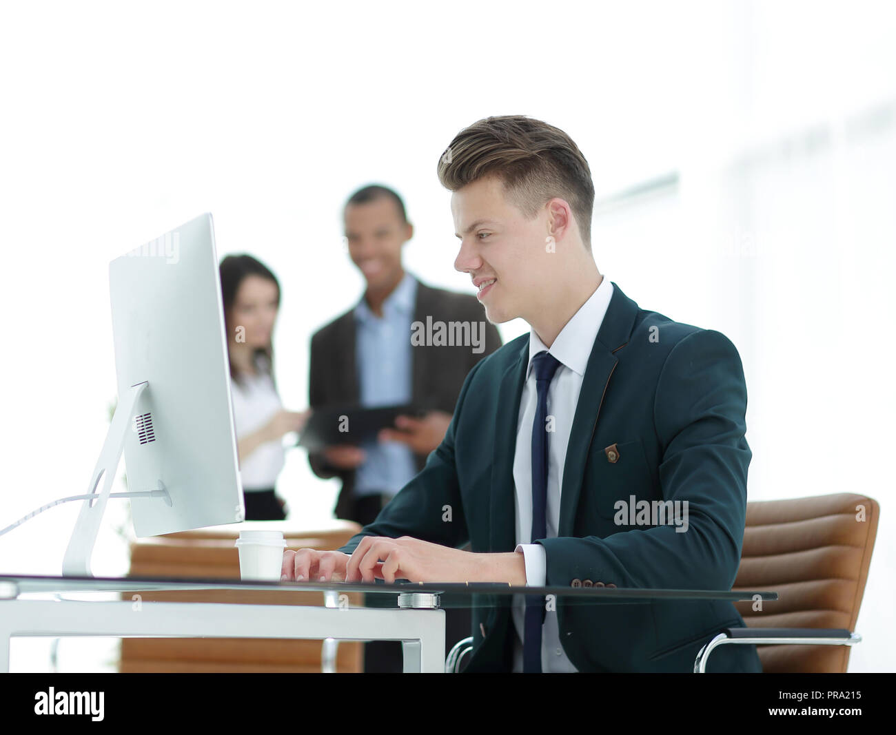 employee sitting behind a Desk in the office Stock Photo - Alamy