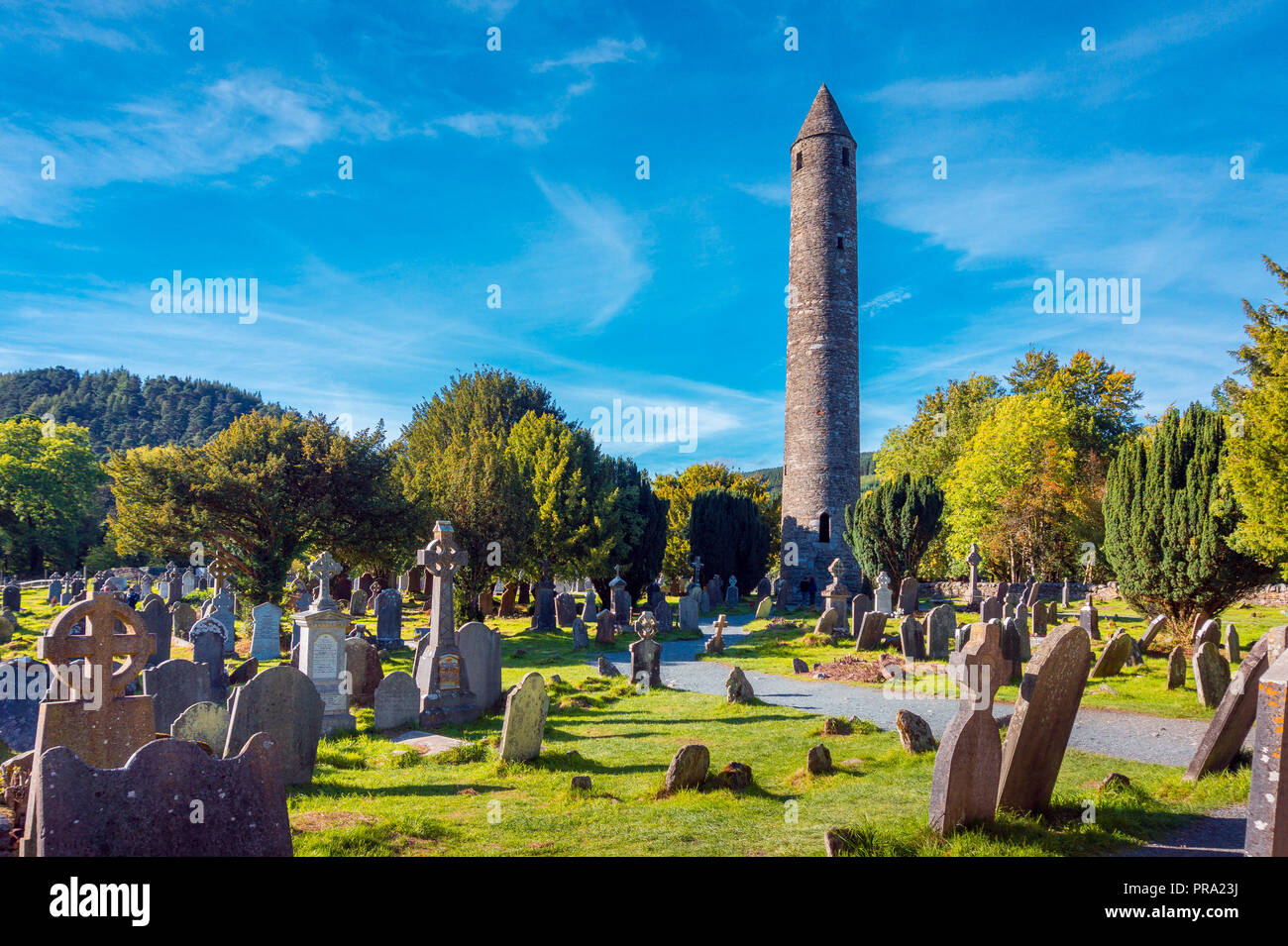Stone round tower and some ruins of a monastic settlement originally ...