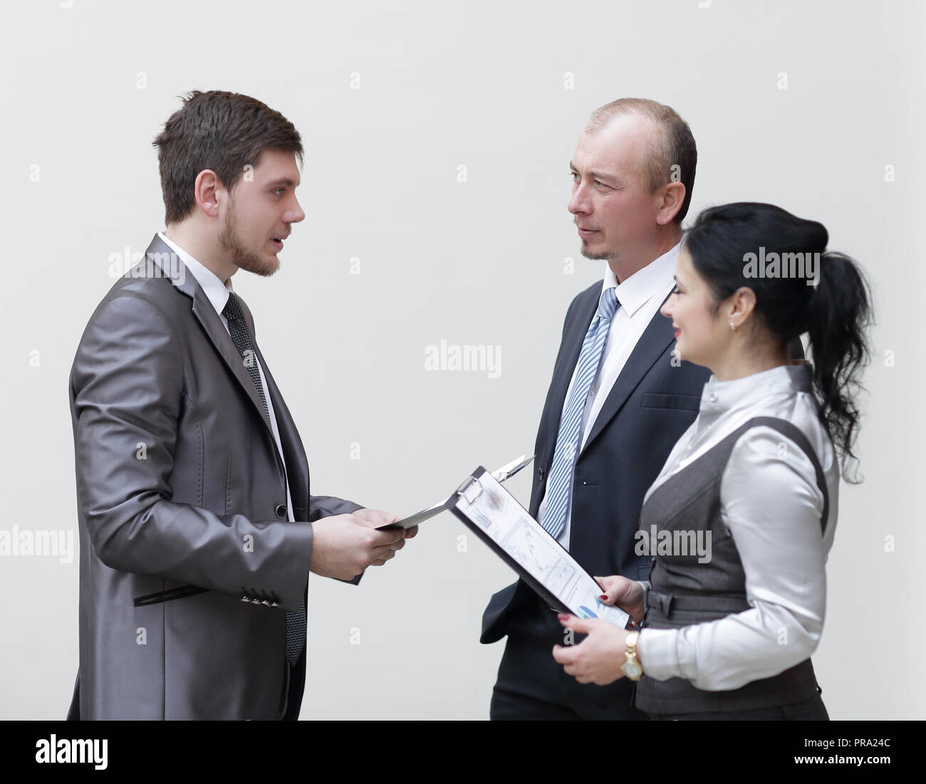 staff discuss business documents,standing in the lobby of the office ...