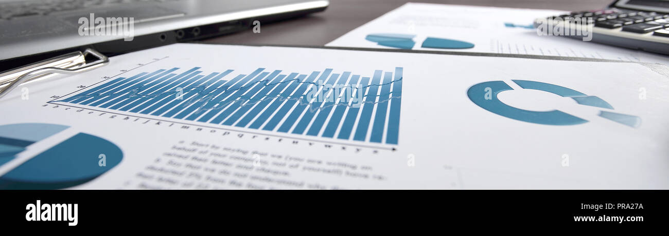 business background. financial report and laptop, on business Desk ...