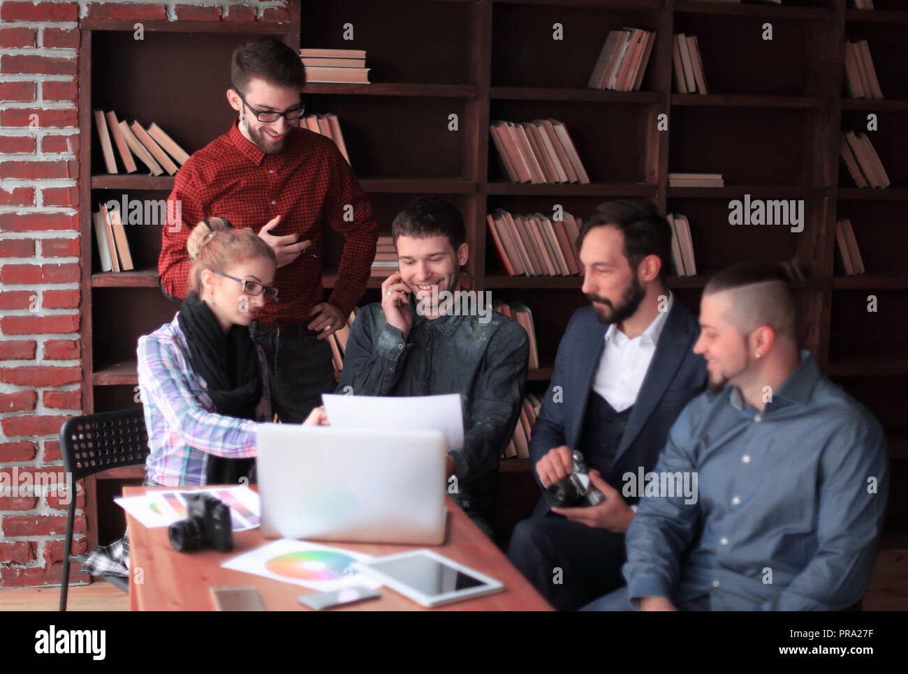 creative group of designers at a working meeting in the Studio Stock ...