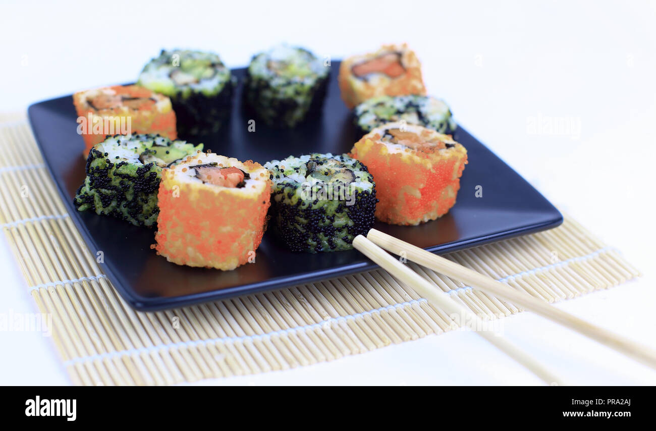 Sushi Set - different types of Maki sushi and chopsticks on a b Stock ...