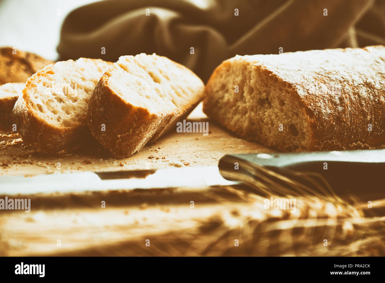 Sliced bread on cutting board on the bench of a kitchen traditional ...