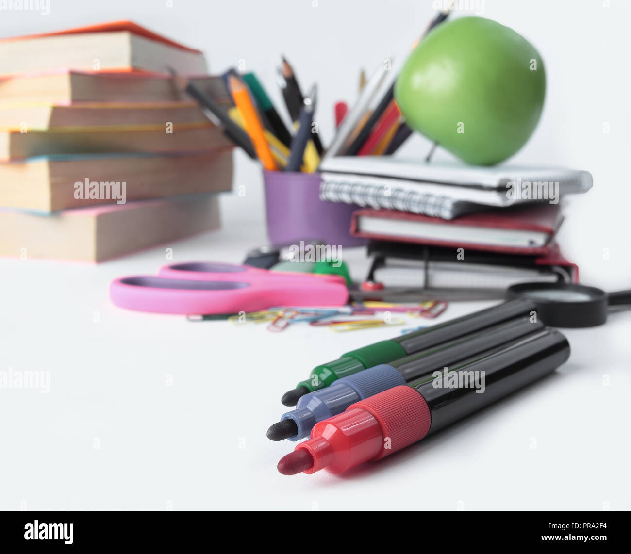 colored markers and school supplies on a white background .concept of ...