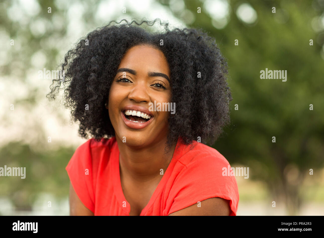 Happy confident African American woman smiling outside Stock Photo - Alamy