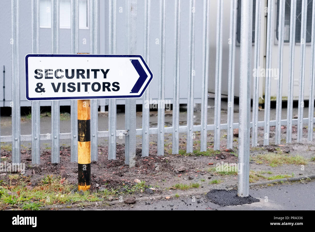 Security and visitors direction arrow sign at entrance of workplace ...