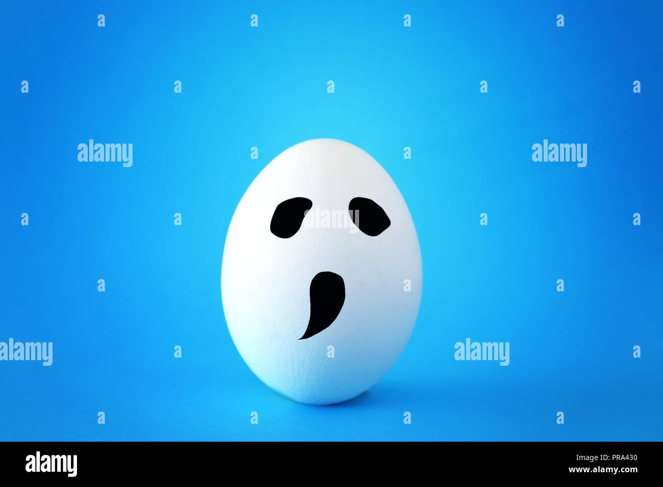 minimal and funny Halloween holiday concept. white egg with scary cute ...