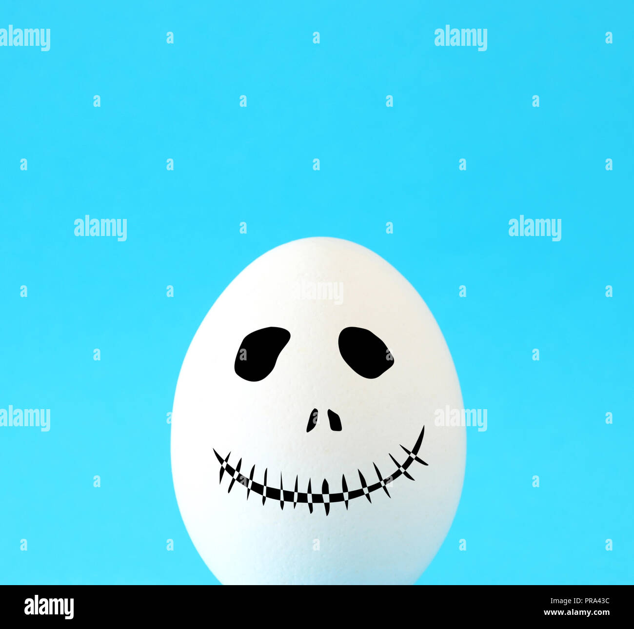 minimal and funny Halloween holiday concept. white egg with scary cute ...