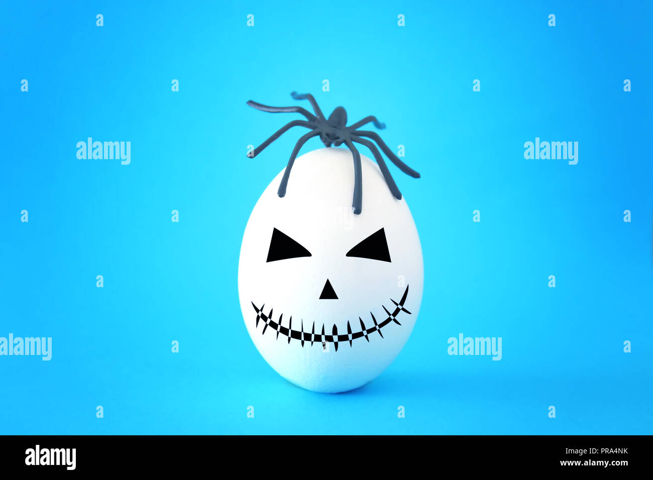 minimal and funny Halloween holiday concept. White egg with scary cute ...