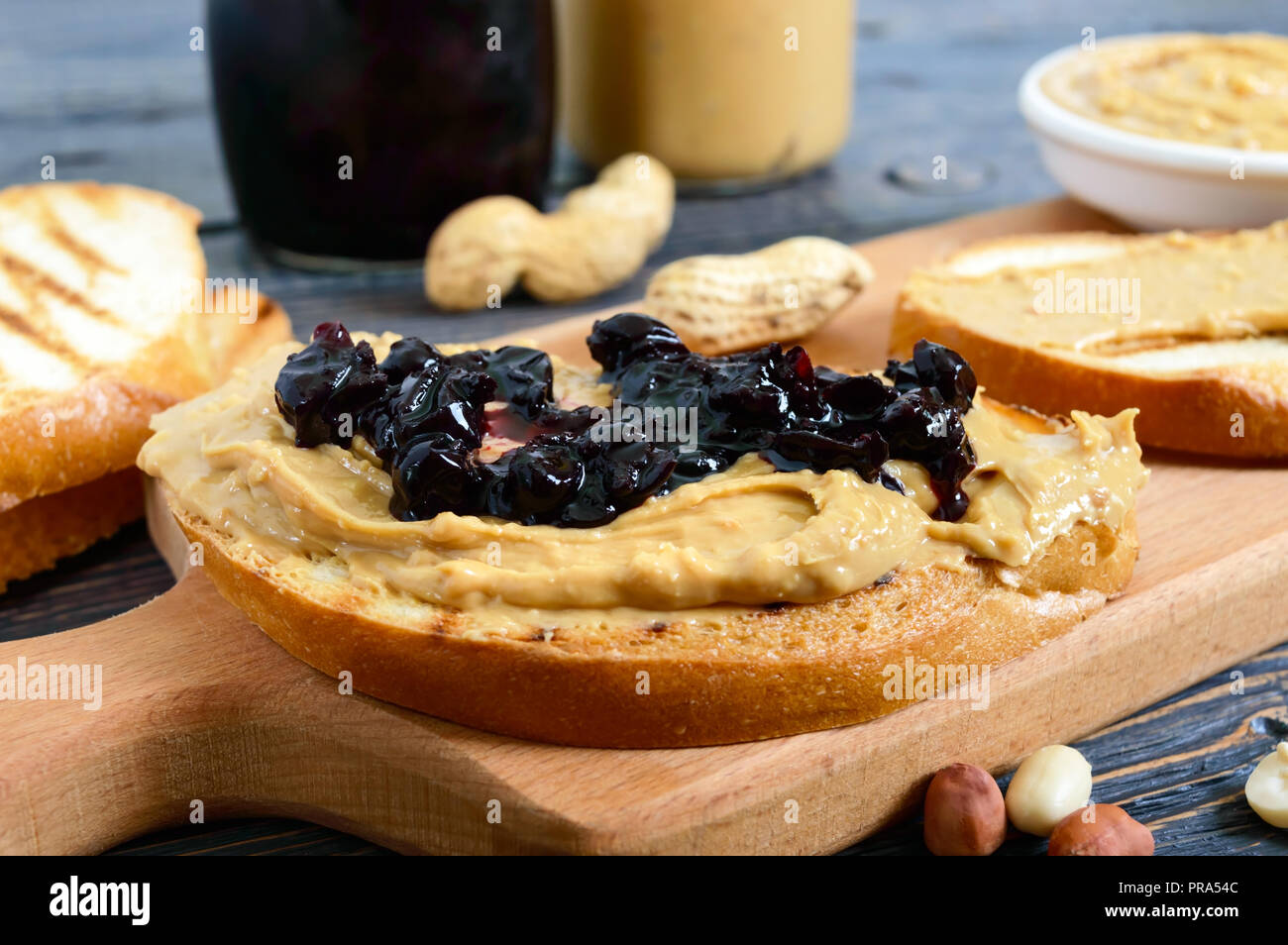 Crispy toast with peanut butter and berry jam. Traditional American ...