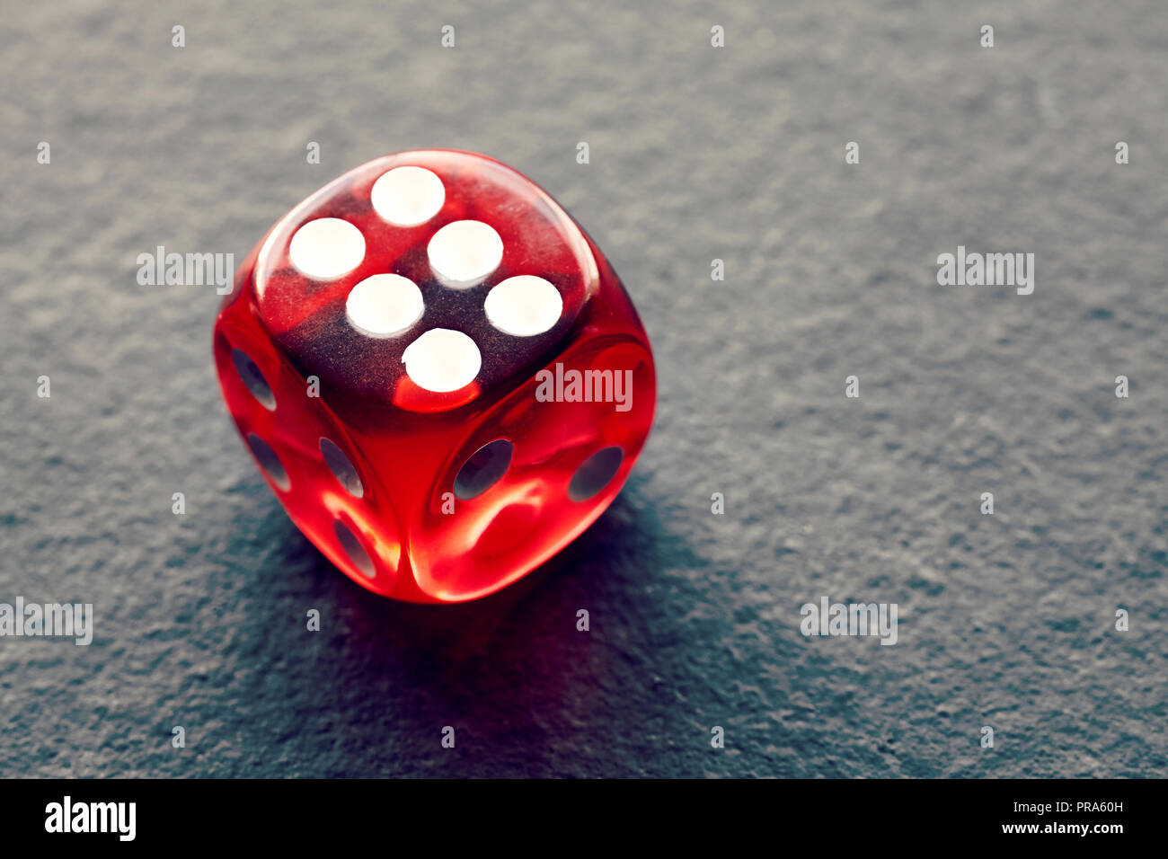 Close up picture of six on a red dice, selective focus, color toning ...
