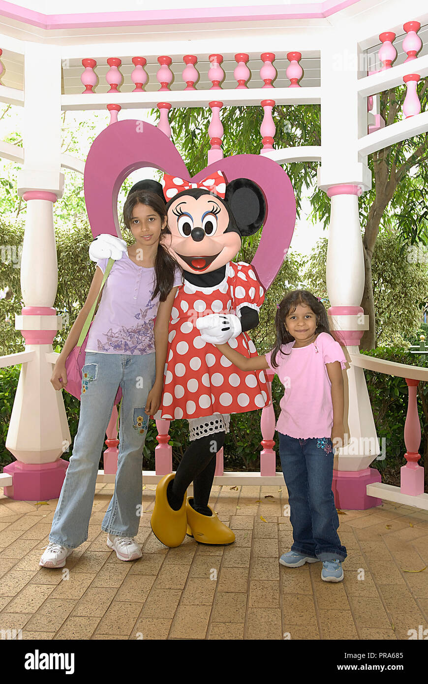 TWO SISTERS POSING FOR A PORTRAIT WITH MINNIE MOUSE AT HONG KONG ...