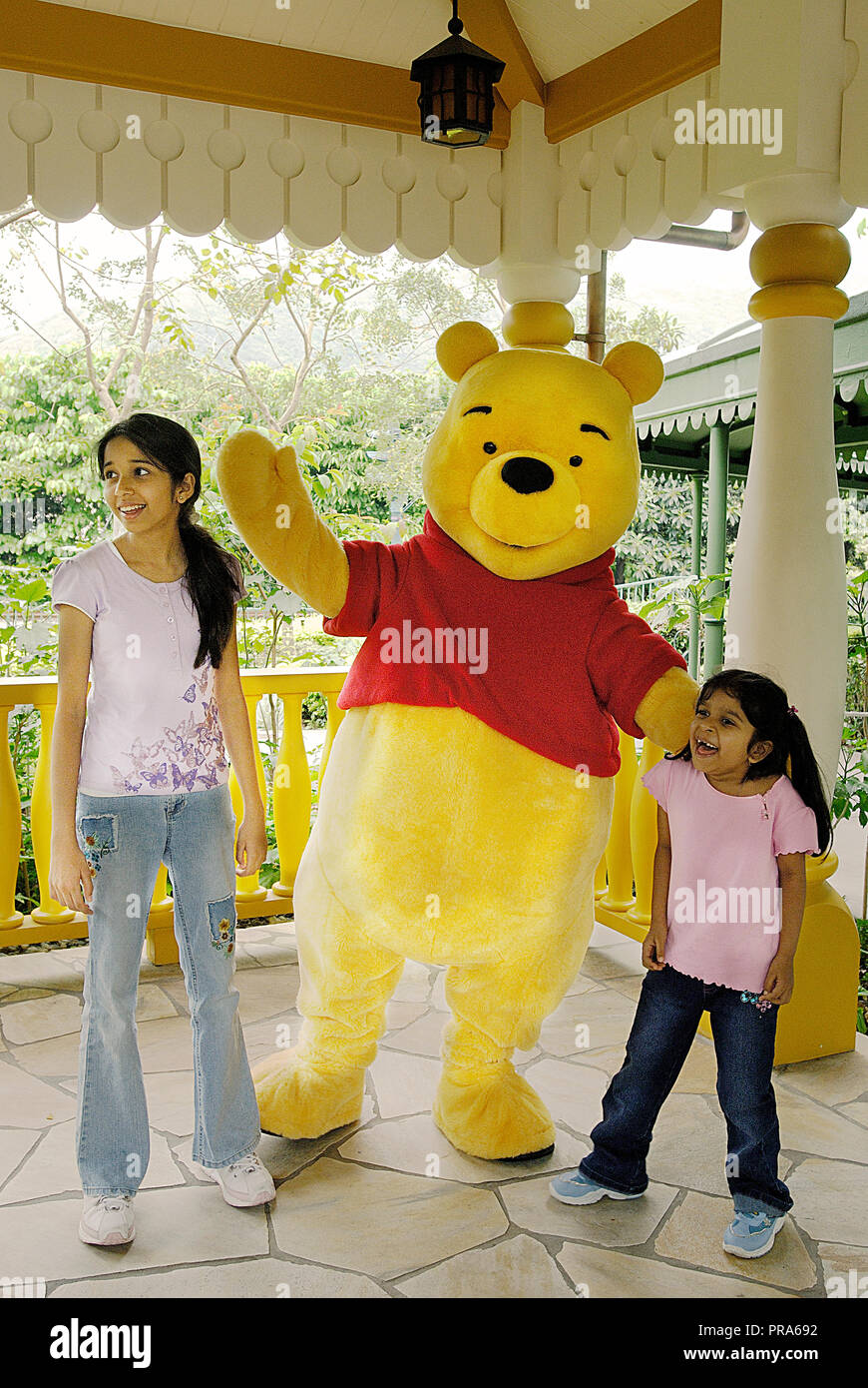 TWO SISTERS POSING FOR A PORTRAIT WITH WINNIE THE POOH AT HONG KONG ...