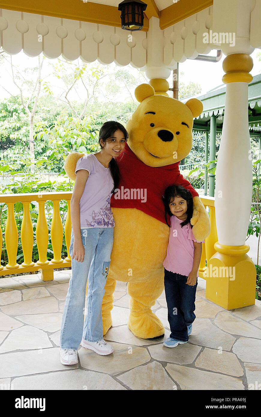 TWO SISTERS POSING FOR A PORTRAIT WITH WINNIE THE POOH AT HONG KONG ...