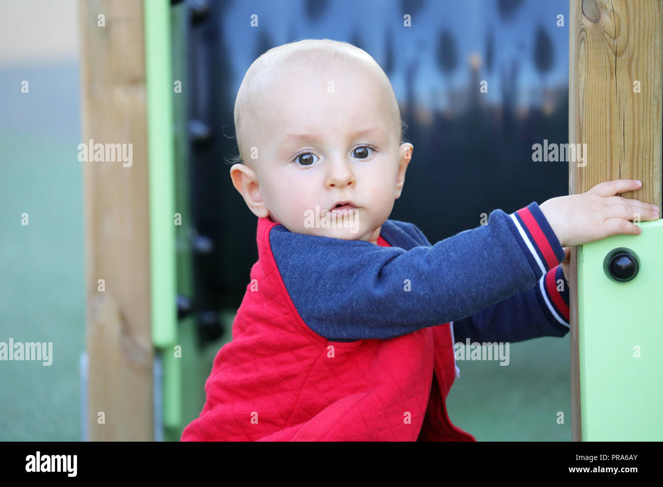 Cute Baby Boy Learning To Stand At The Outdoor Playground. Close Up ...