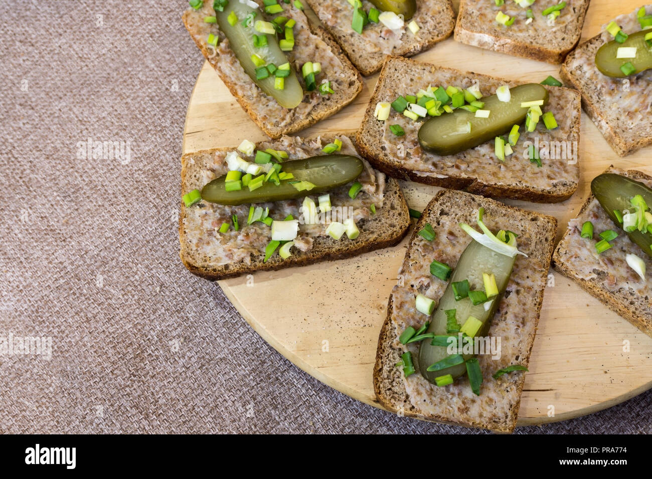 Homemade lard and pickled cucumbers on a slices of bread. Traditional ...