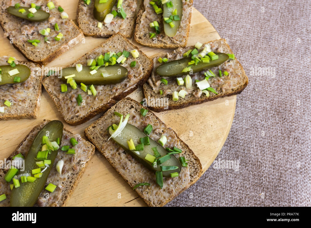 Homemade lard and pickled cucumbers on a slices of bread. Traditional ...