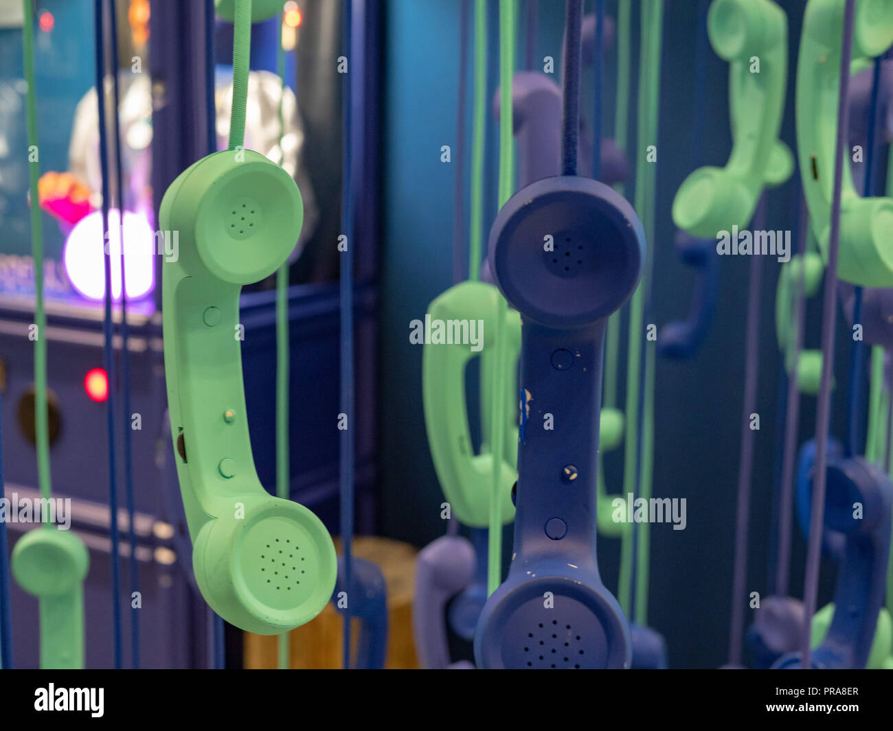 Blue and green hanging foam novelty telephone receivers Stock Photo - Alamy