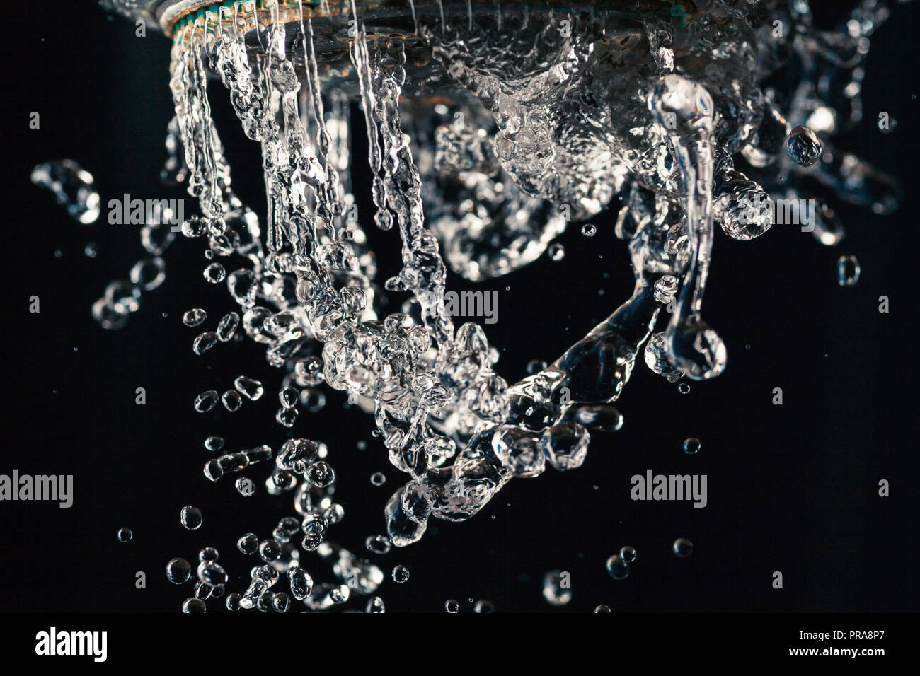 Water drops levitating about shower head on black background Stock ...