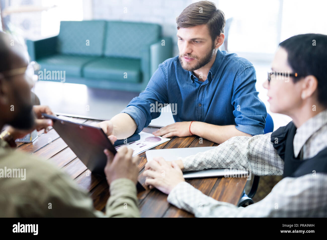 Modern team analyzing data together Stock Photo - Alamy