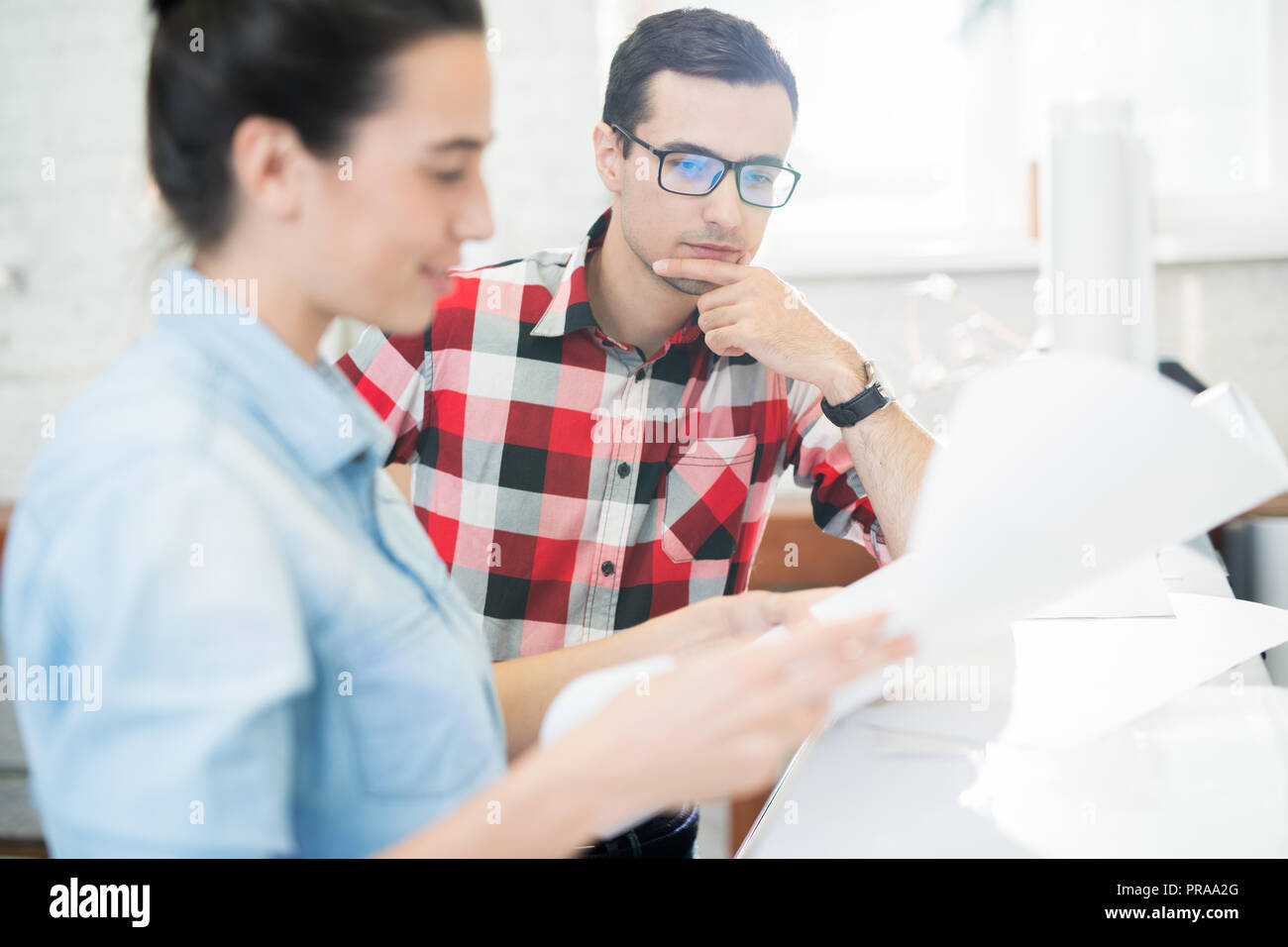 Colleagues examining papers together Stock Photo - Alamy