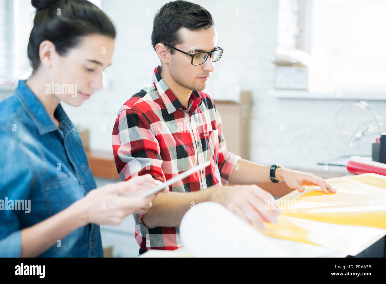 Staff of printing company working with colorful paper Stock Photo - Alamy