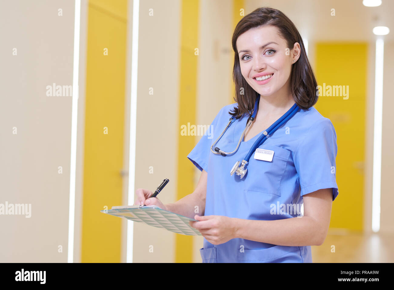 Smiling Nurse Posing in Clinic Stock Photo - Alamy