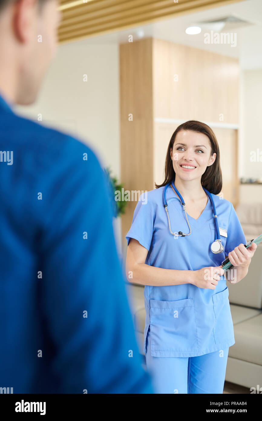 Smiling Nurse Greeting Patient Stock Photo - Alamy