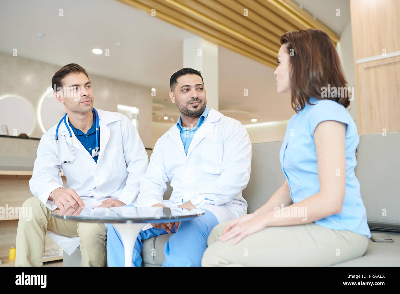Two Doctors Consulting Patient Stock Photo - Alamy