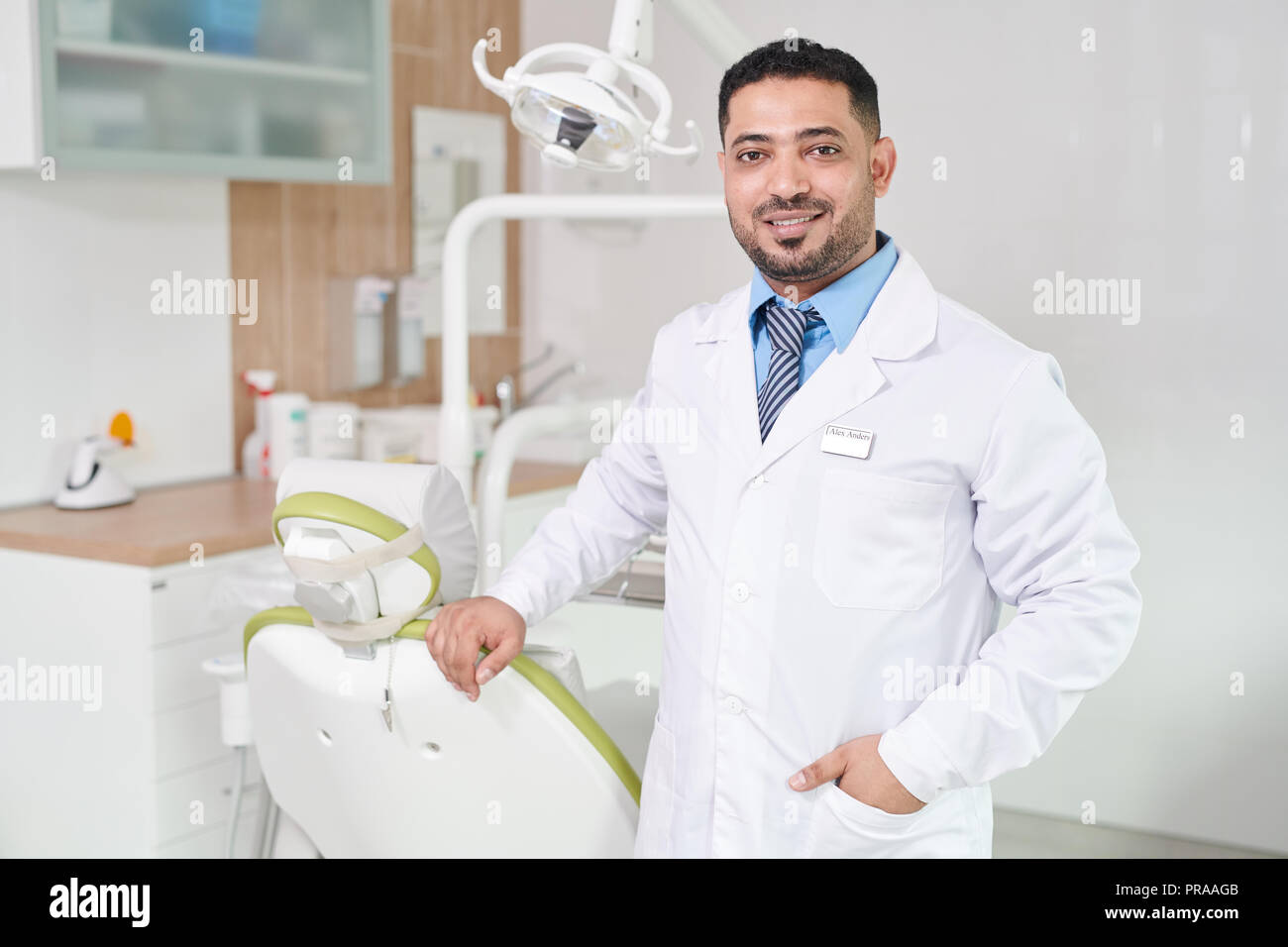 Middle-Eastern Dentist Posing by Chair Stock Photo - Alamy