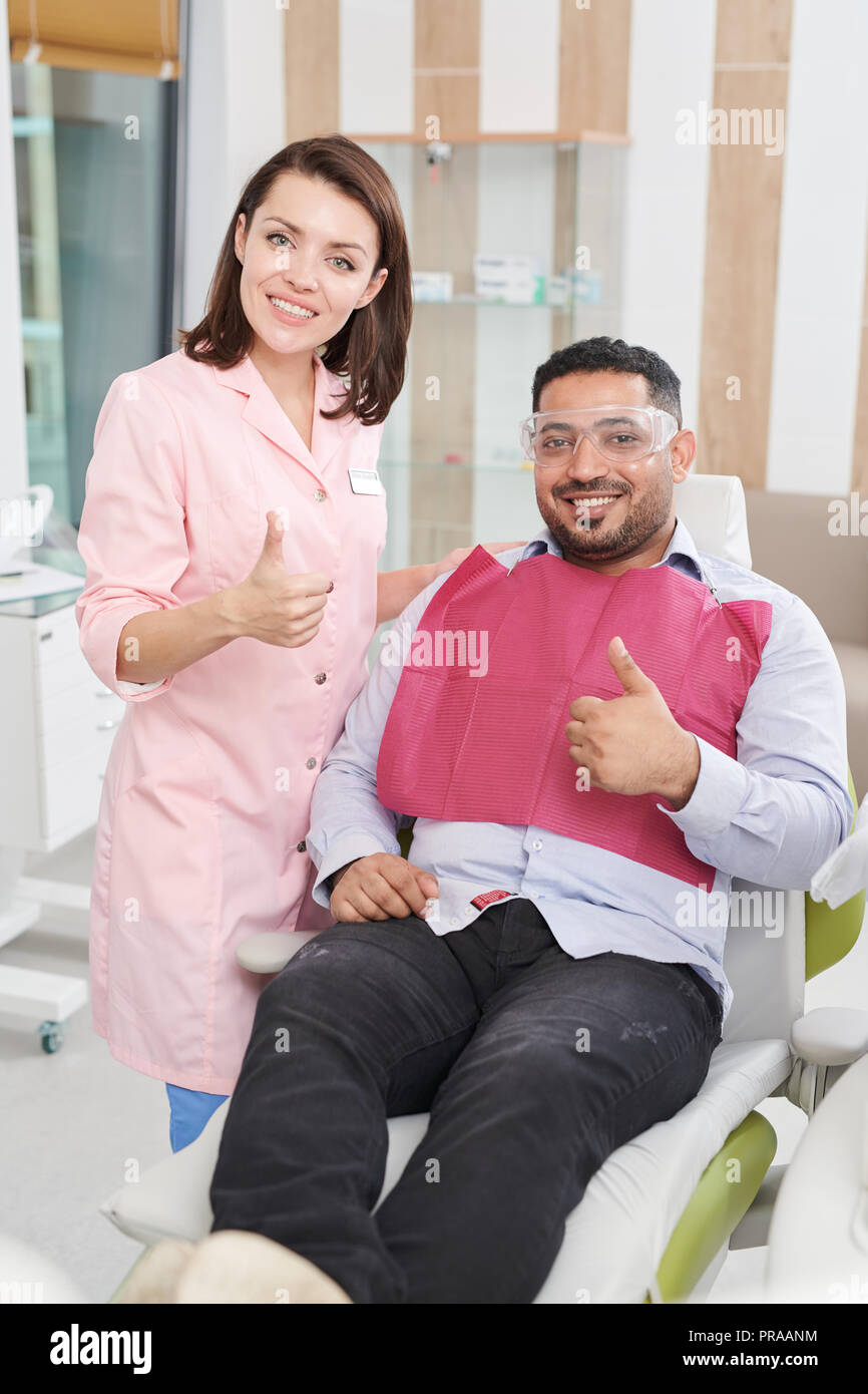 Female Dentist Posing with Patient Stock Photo - Alamy