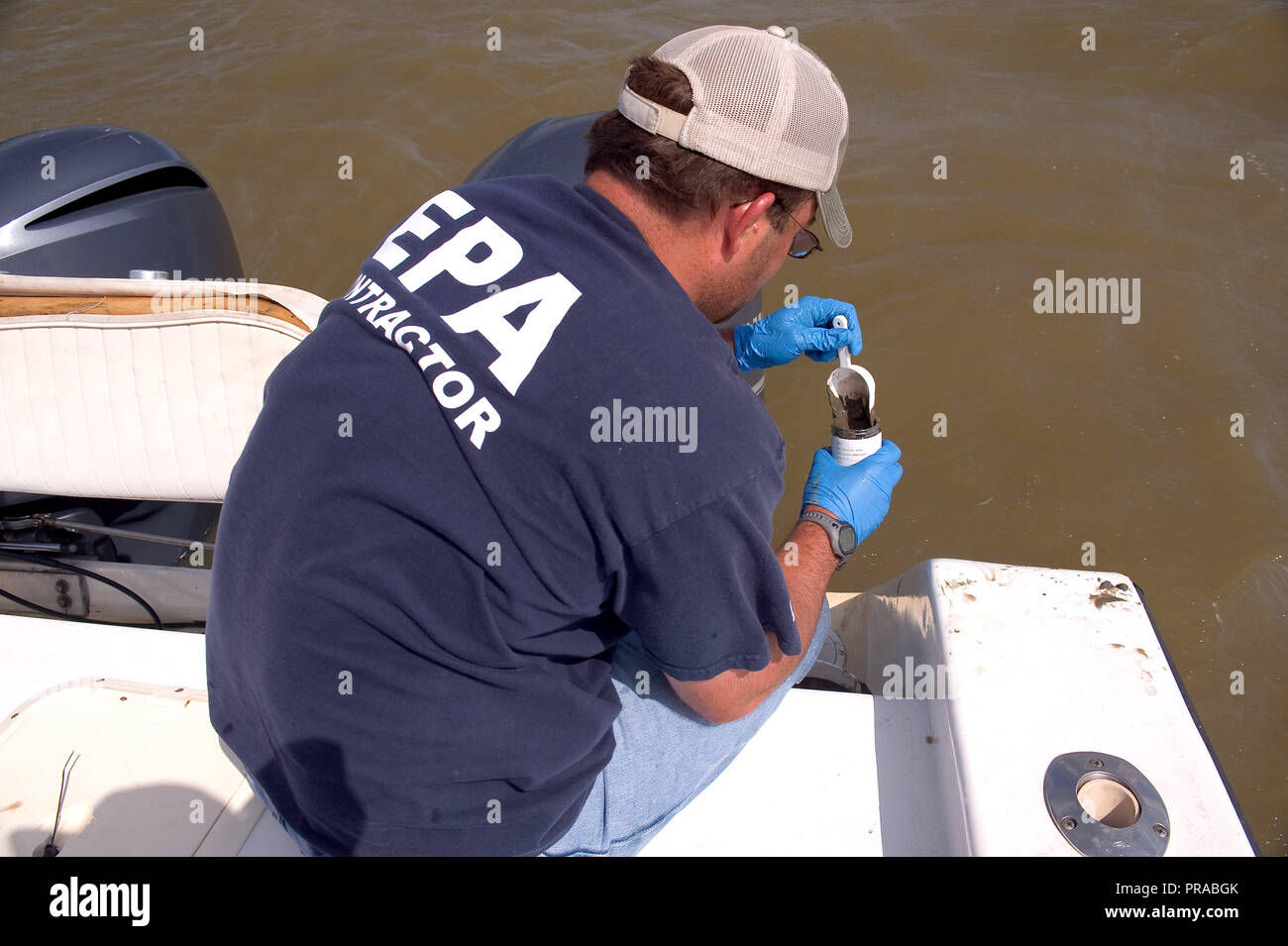 An EPA contractor taking sediment samples in the Gulf of Mexico during ...