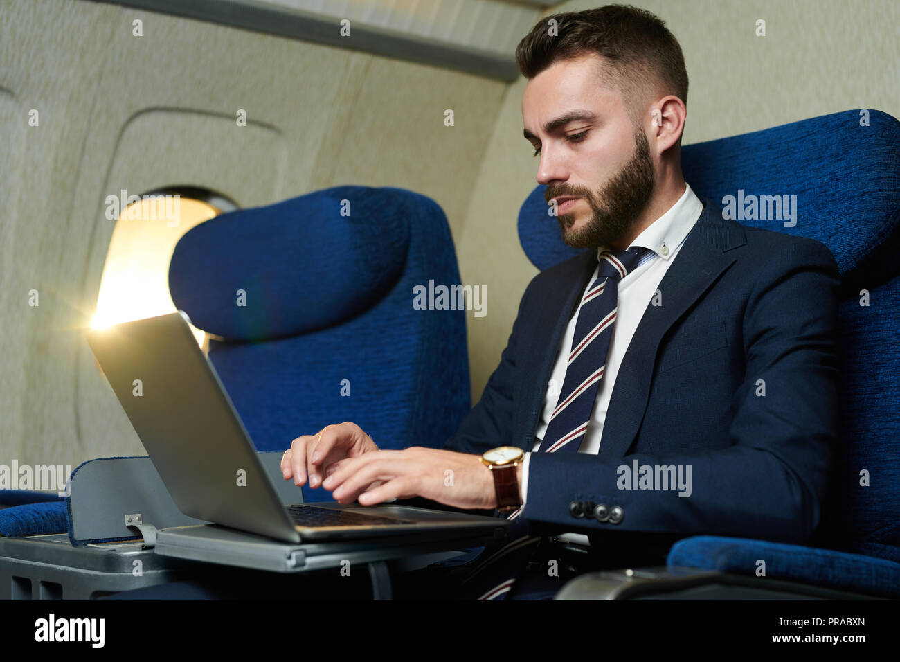 Businessman Working in Plane Stock Photo - Alamy