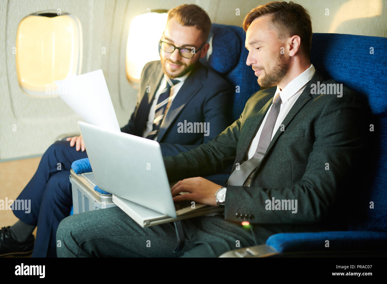 Unrecognizable Businessman in Plane Stock Photo - Alamy