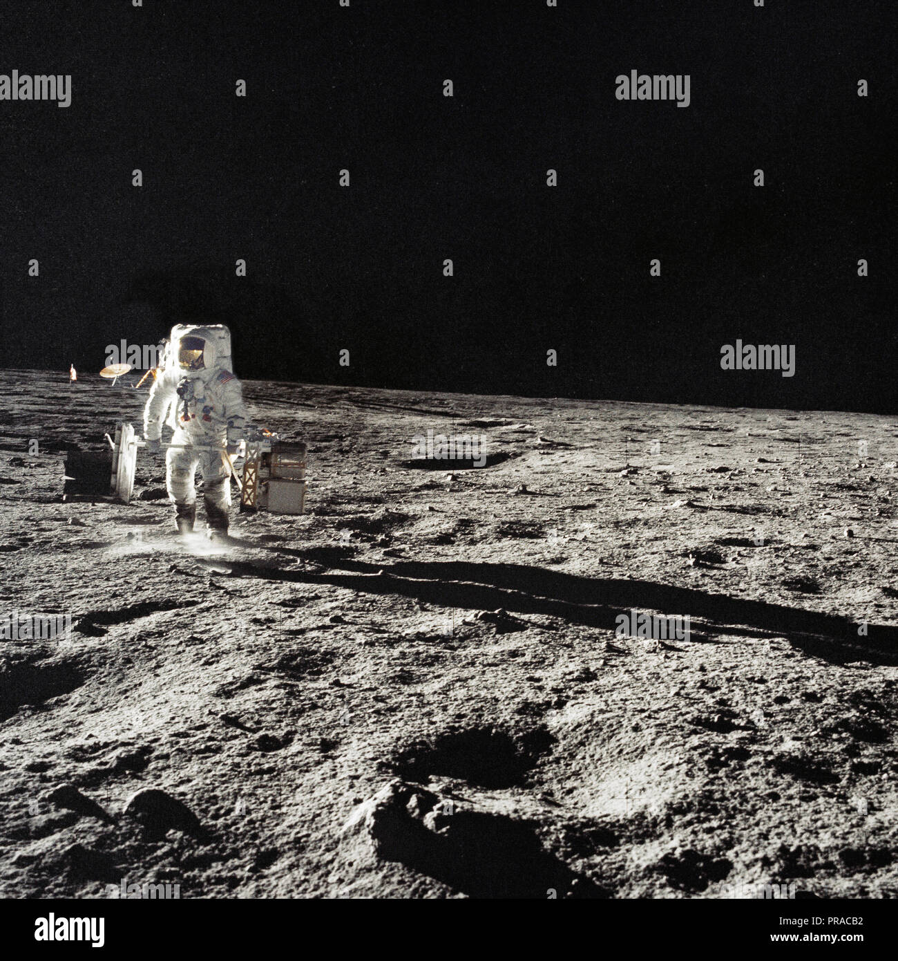 Astronaut Alan L. Bean, lunar module pilot, traverses with the two sub ...