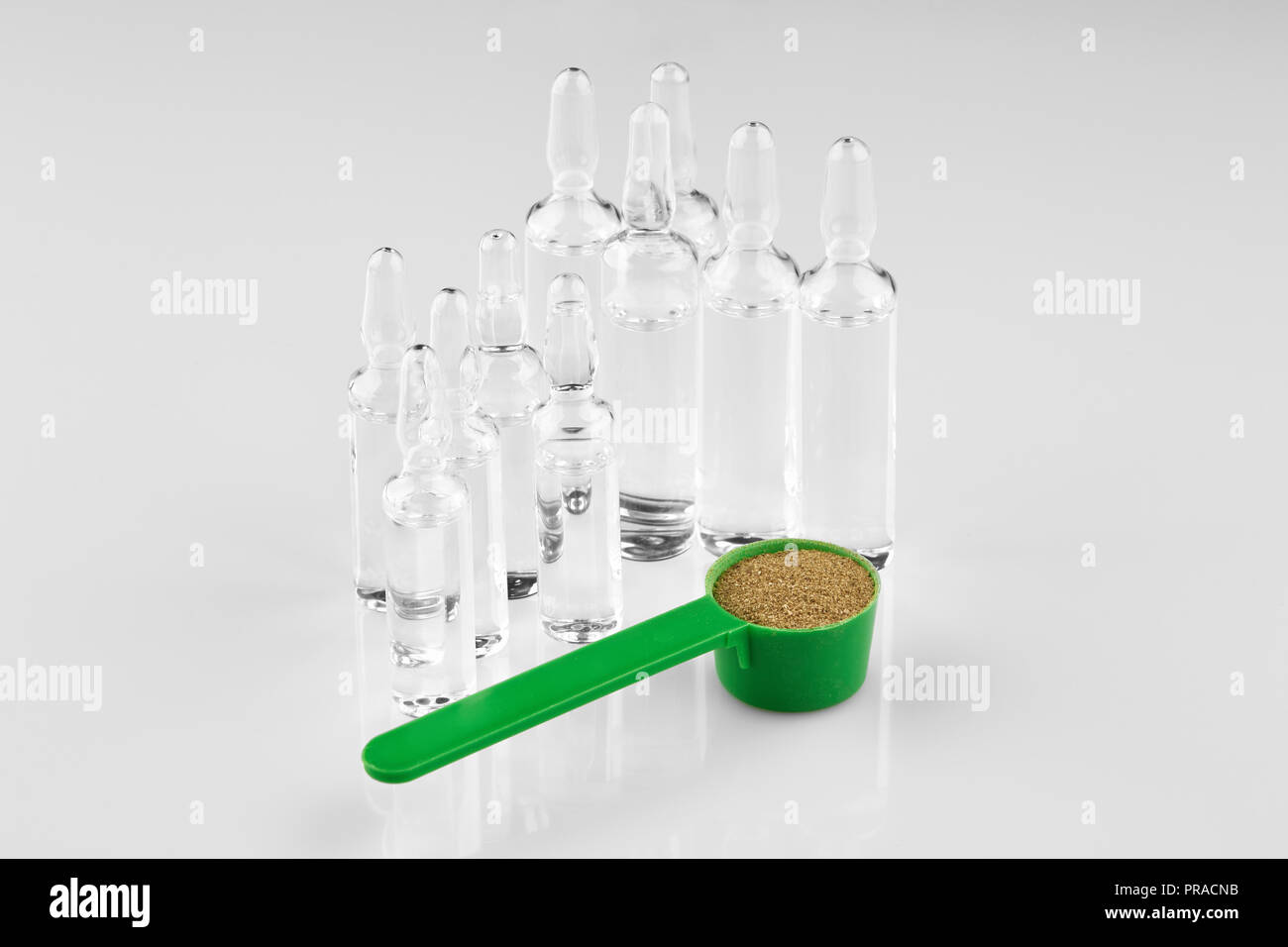 Brown medicine powder and ampoules on white background Stock Photo - Alamy
