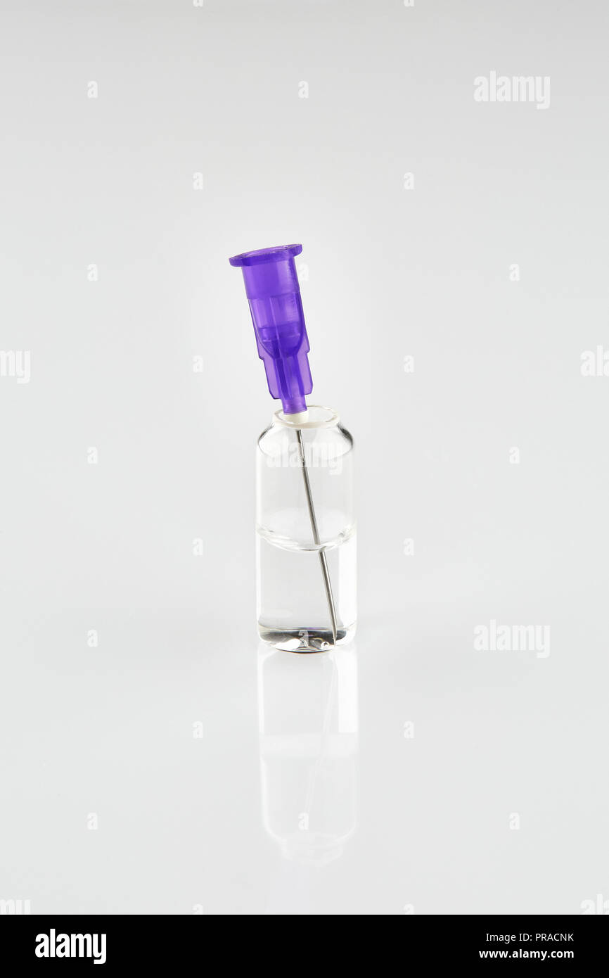 Violet syringe needle in ampoule with medicine Stock Photo - Alamy