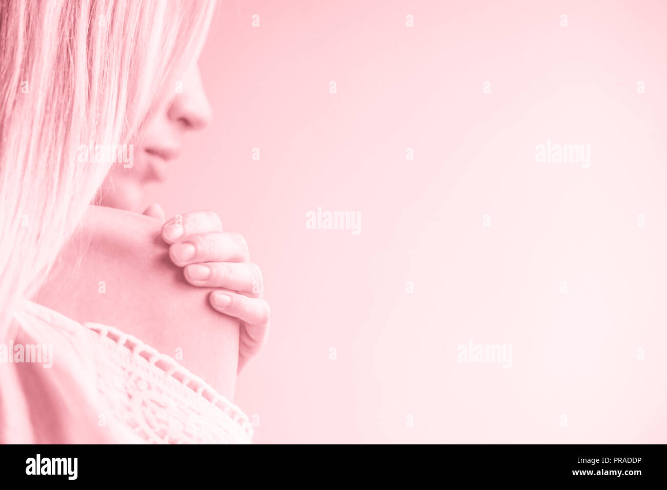 Young woman in white clothes, holds her hand on shoulder. Rear view in ...