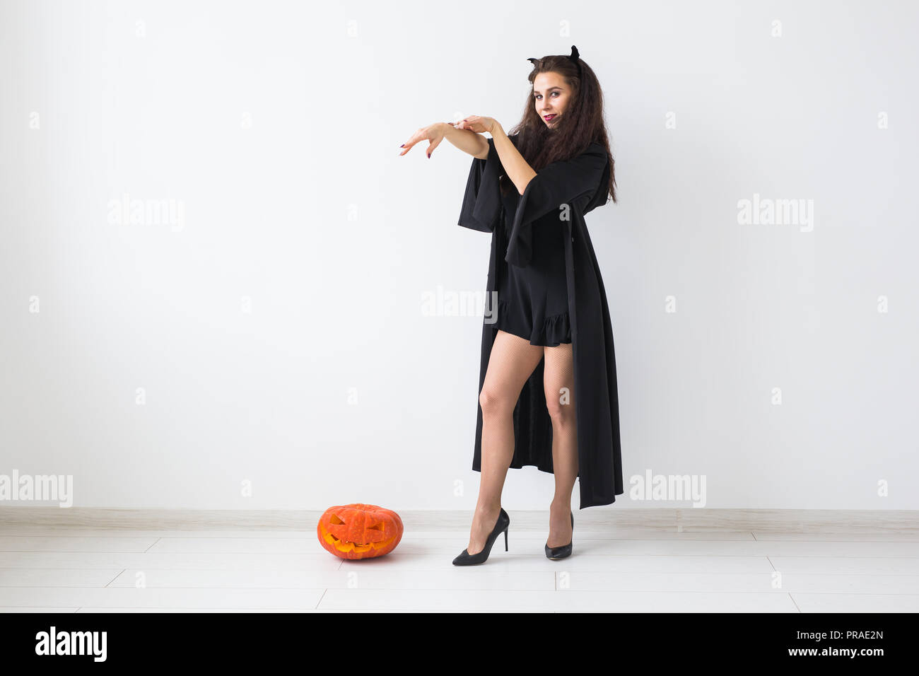 Halloween and holidays concept - Witch woman with Jack O'Lantern ...