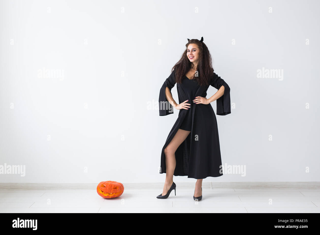 Halloween and holidays concept - Witch woman with Jack O'Lantern ...