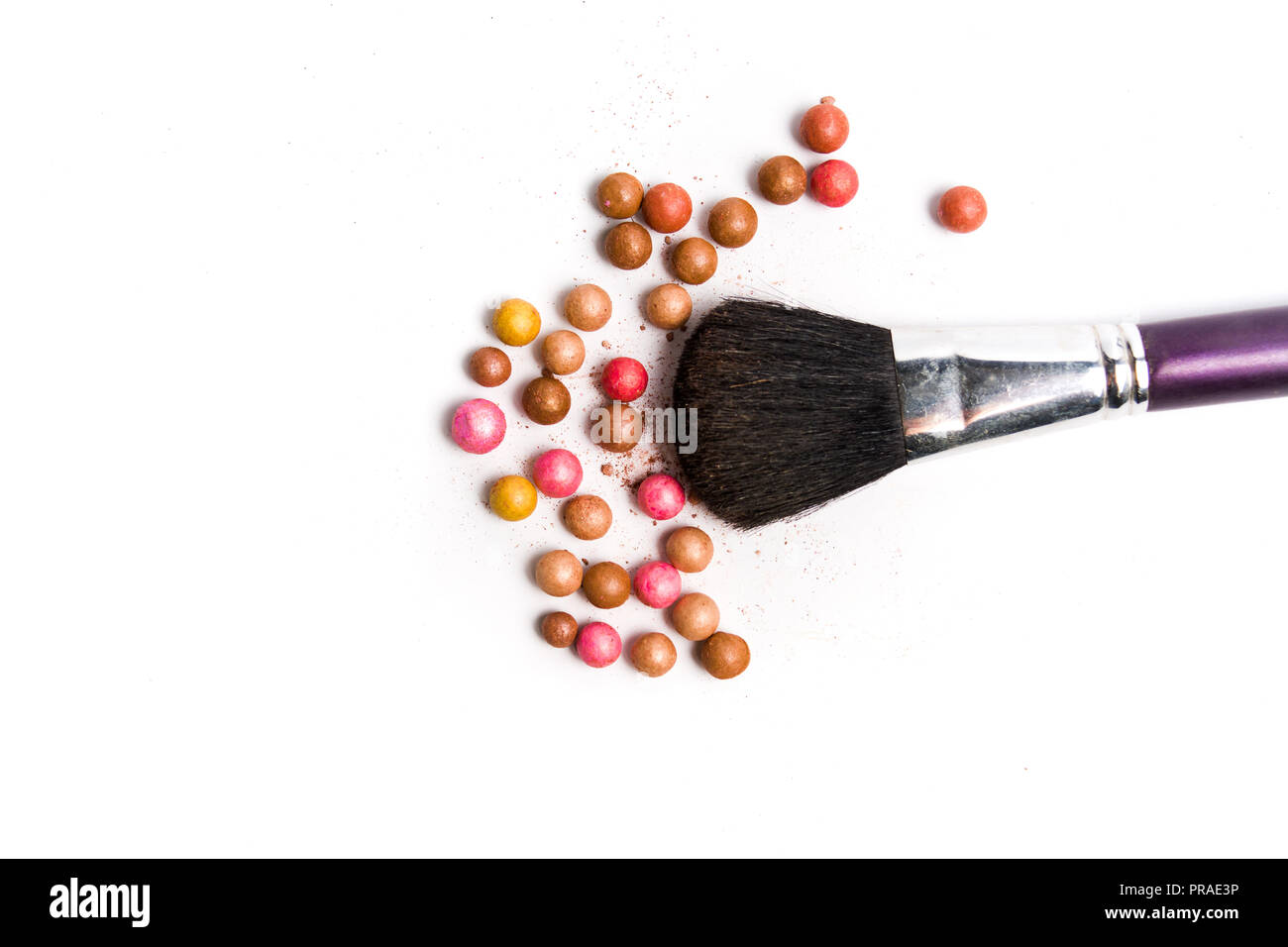 Pink and purple makeup balls with brush on white background isolated ...