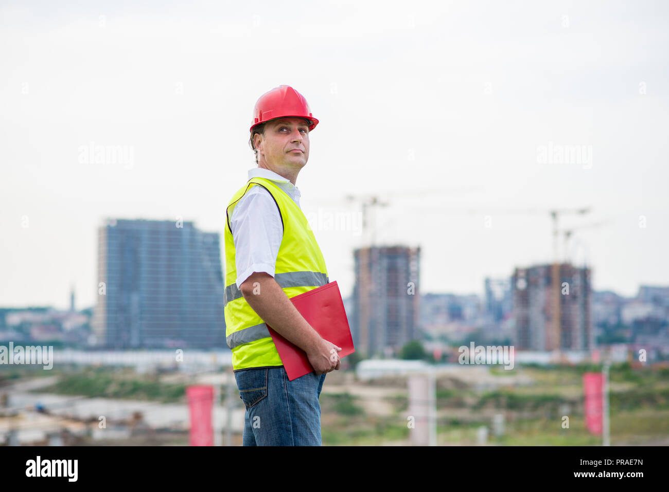 Engineer on a construction site wearing protective work wear with ...