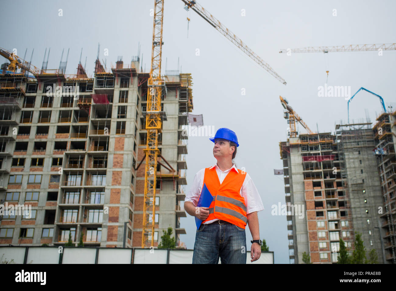 Architect on a construction site during a housing project Stock Photo ...