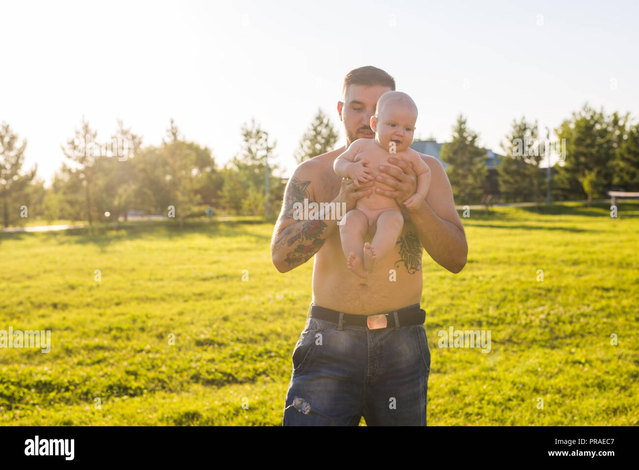 Happy father holding baby son on nature. Concept of happy family ...