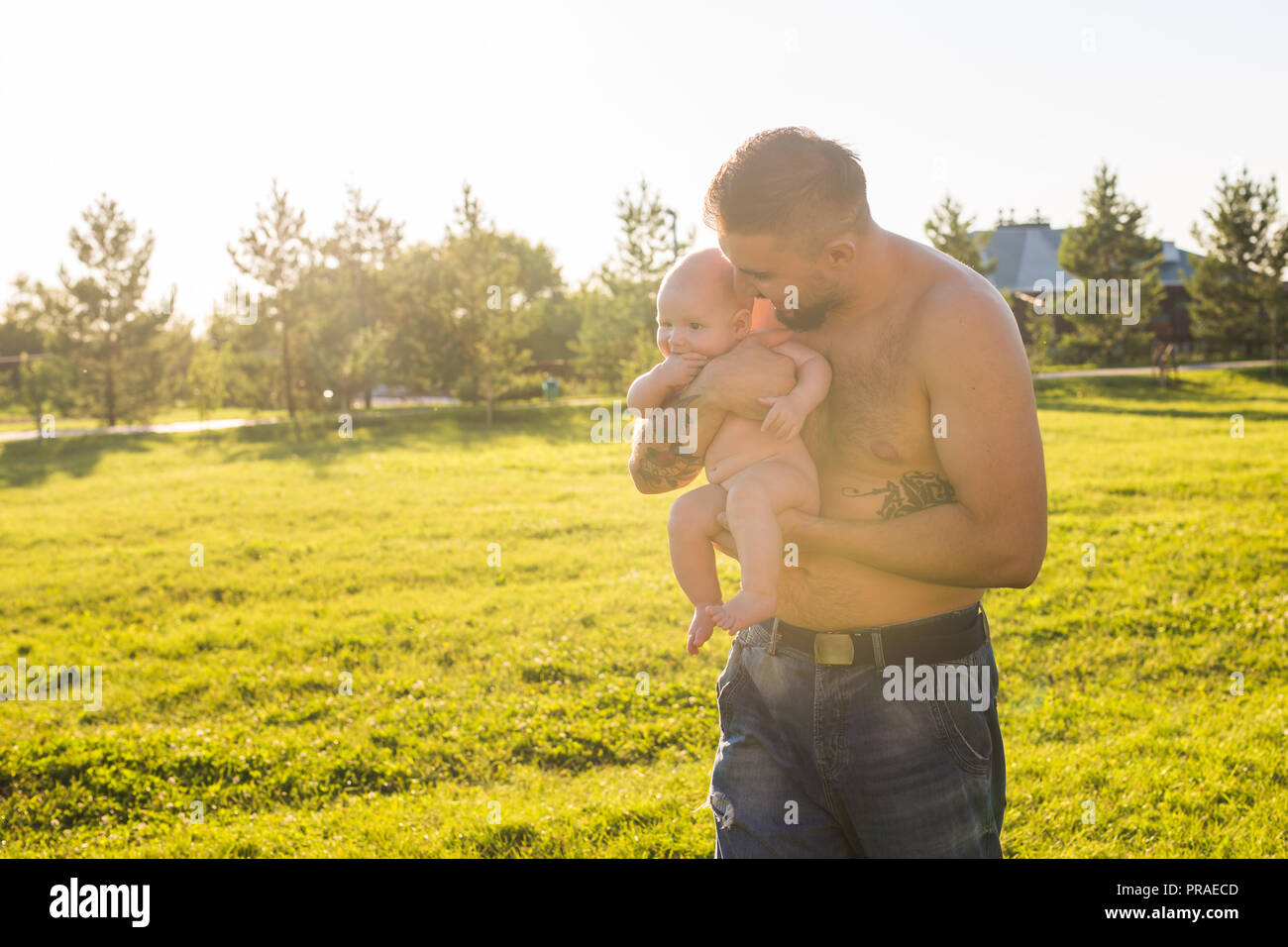 Happy father holding baby son on nature. Concept of happy family ...